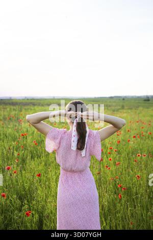 A red wild poppy flower in the green field Stock Photo - Alamy
