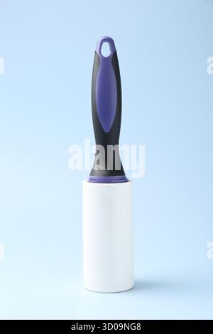 One lint roller on light grey background, top view Stock Photo - Alamy