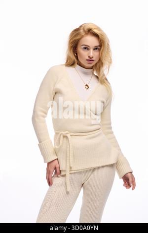 Beautiful blonde woman displays her trendy denim outfit against a warm ...