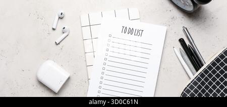 Blank to do list, earphones and stationery supplies on grunge table ...