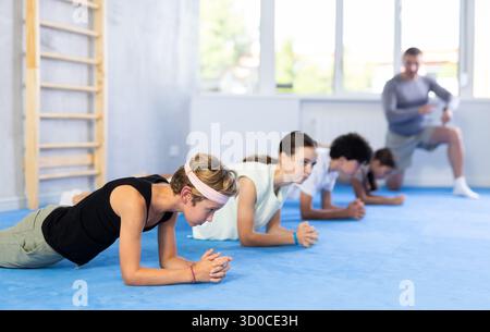 Child pupils performs plank exercises Stock Photo - Alamy