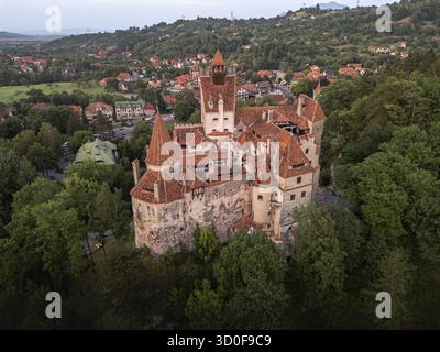 Aerial view of the imposing Bran Castle, its red-tiled roofs ...