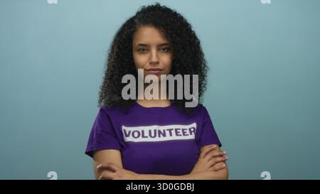 Young latin woman wearing volunteer uniform working at charity center ...