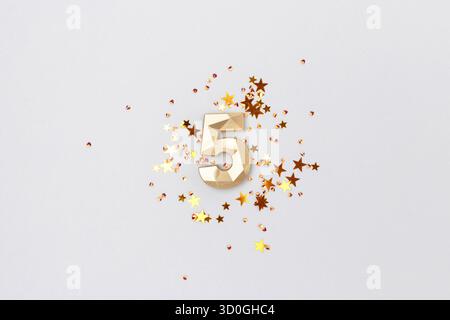 Flat lay composition of five golden fried spring rolls topped with ...