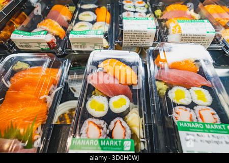 A supermarket shelf displaying various pre-packaged Asian meals in ...