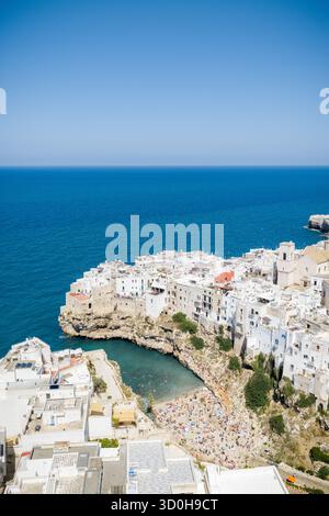 Aerial view of a tiny sandy beach surrounded by cliffs on the coast of ...
