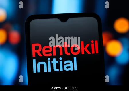 In this photo illustration, the Rentokil Initial company logo is seen ...