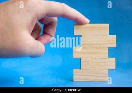 Hand holding wooden block with customizable space for text or ideas ...