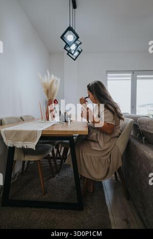 Dining table, vase of pampas grass and wine bottle in room Stock Photo ...