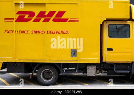 German express delivery mail company DHL employees prepare numerous ...