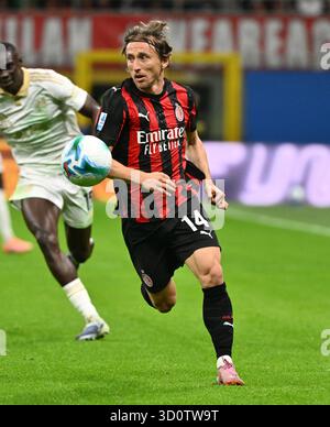 Luka Modric of AC Milan competes for the ball with Nicolae Stanciu of ...