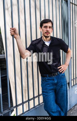 Man confidently looking at camera standing behind bar Stock Photo - Alamy