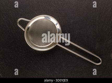 Metal kitchen sieve on slate stone, top view Stock Photo - Alamy