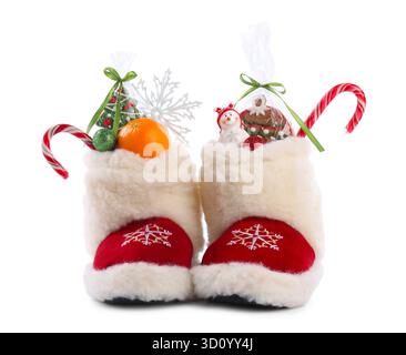 Saint Nicholas day. Boots with treats and fir tree branches isolated on ...