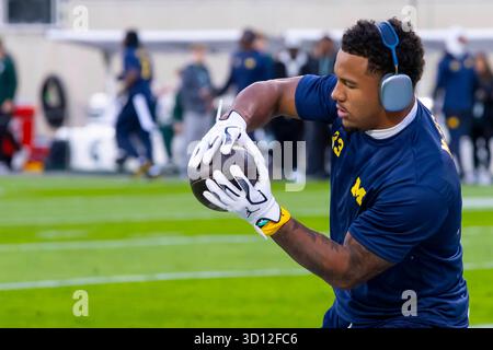 Michigan running back Jordan Marshall (23) loses the ball after rushing ...