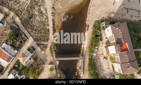 A small bridge above a river surrounded with greenery in a Japanese ...