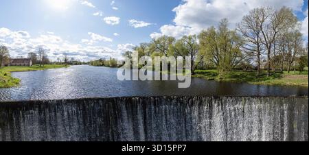 Water flows from a small semi-circular dam in a small village by the ...