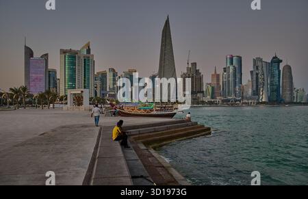Doha Qatar skyline from corniche promenade at sunset showing West Bay ...