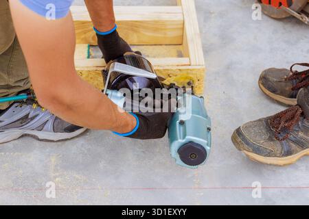 Worker is assembling wooden frame beams trusses during work day Stock ...
