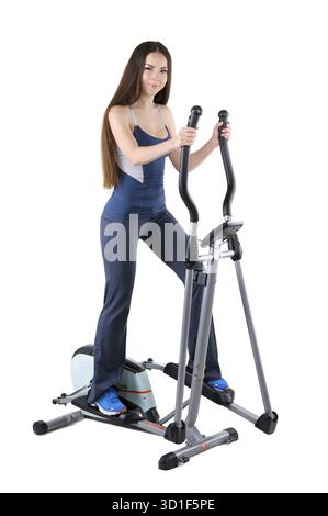Woman training on elliptical trainer in gym Stock Photo - Alamy
