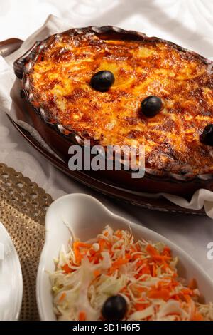Bacalhau com natas - baked cod with potatoes, onions and cream in a ...