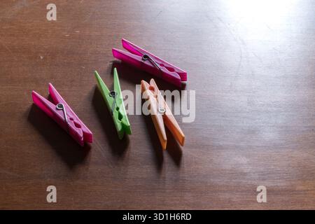 Two wooden clothespins on pink background Stock Photo - Alamy