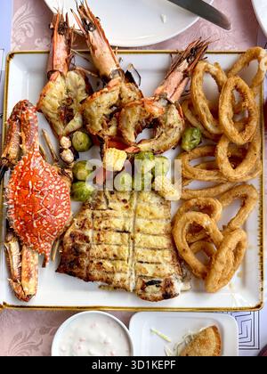 Assorted fresh fish, prawns and seafood displayed on crushed ice in a ...