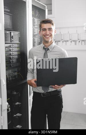 Cropped portrait of young data scientist using laptop computer in ...