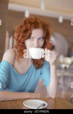 Beautiful young woman with cup of tasty coffee at home Stock Photo - Alamy