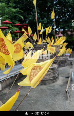 Dharmacakra yellow flags on a buddhist temple in Chiang Rai, Thailand ...