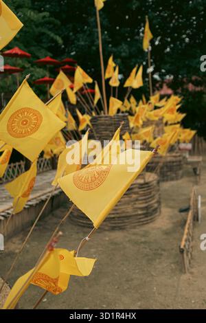 Dharmacakra yellow flags on a buddhist temple in Chiang Rai, Thailand ...