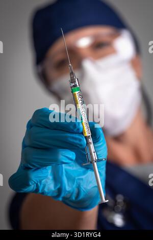 doctor with latex gloves while administering the vaccine on the arm of ...