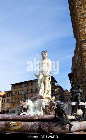 A grand marble statue of Neptune towers over a ornate fountain in a ...