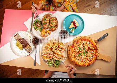 Restaurant café feast serving bruschetta and club sandwiches with hand ...