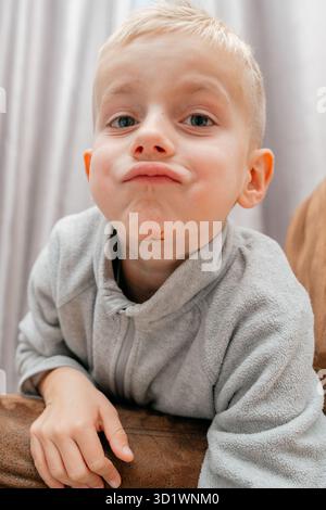 Photo portrait small boy thoughtful showing blank space with fingers ...