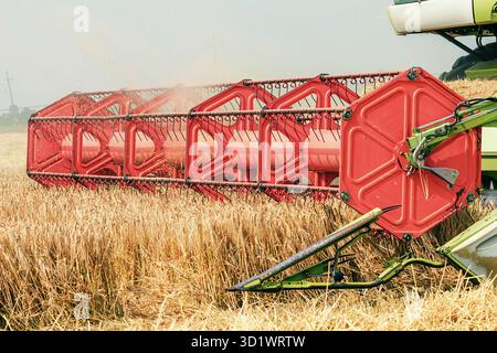 Closeup Combine harvesting a wheat field. Combine working the field ...