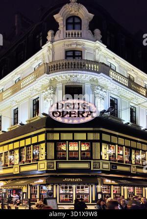 Illuminated exterior facade of the Drug Opera restaurant at night ...