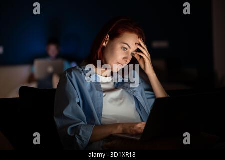 Middle age woman working at night using computer laptop smiling with ...