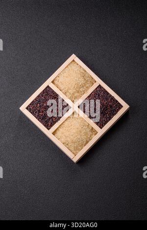Jasmine rice in bowl and sack on old wooden table background with copy ...