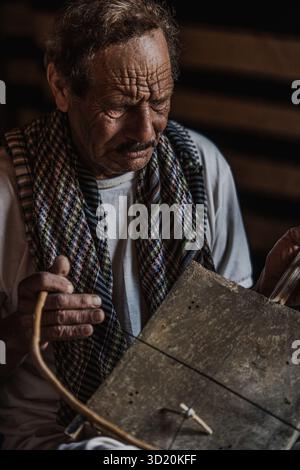 Bedouin musician performing alone on his rababa instrument inside a ...