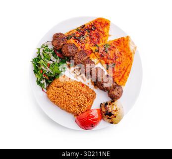 Grilled kebabs with vegetables and rice served on a plate Stock Photo ...