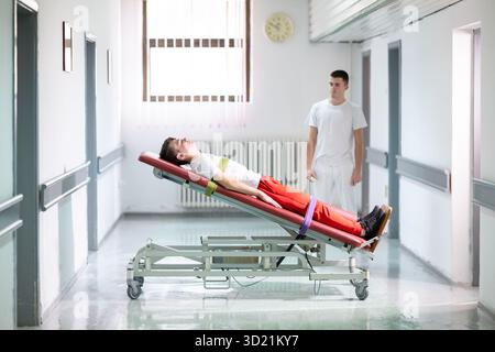 Rehabilitation with Standing Frame.Male therapist assists patient with ...