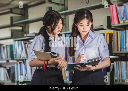 Smart students women teen in uniform with friend in modern school ...
