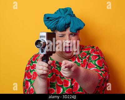 Retro plus size woman filming with vintage camera Stock Photo - Alamy