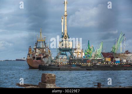 Shipyard site with ships and cranes in Klaipėda, Lithuania Stock Photo ...