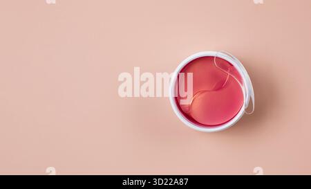 Pink hydrogel eye patches in a box. Banner with cosmetology concept and ...