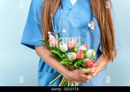 Female doctor with syringe and flowers on beige background Stock Photo ...
