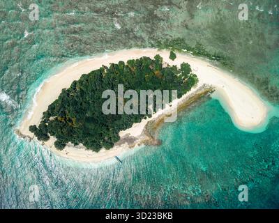 An aerial shot of a small island surrounded by a waterscape and ...