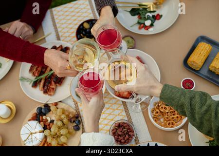 Group of friends enjoy a gathering outdoors. They share laughter and ...