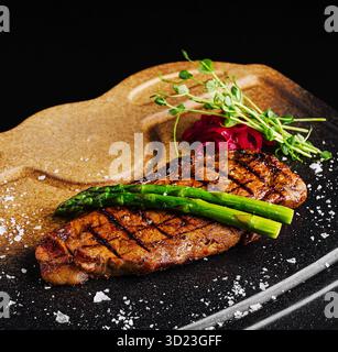 Appetizing beef steak with asparagus on plate Stock Photo - Alamy
